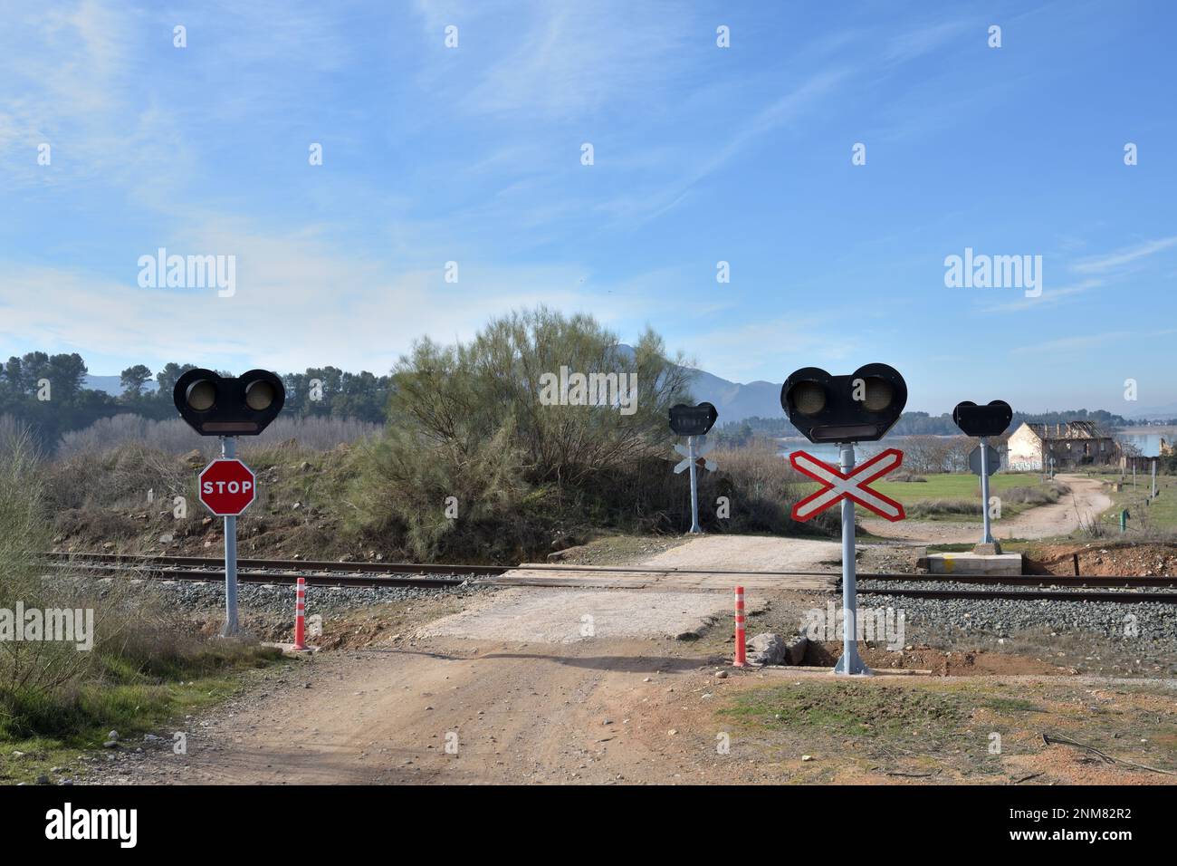 Warning signs on a road that crosses the train tracks Stock Photo - Alamy