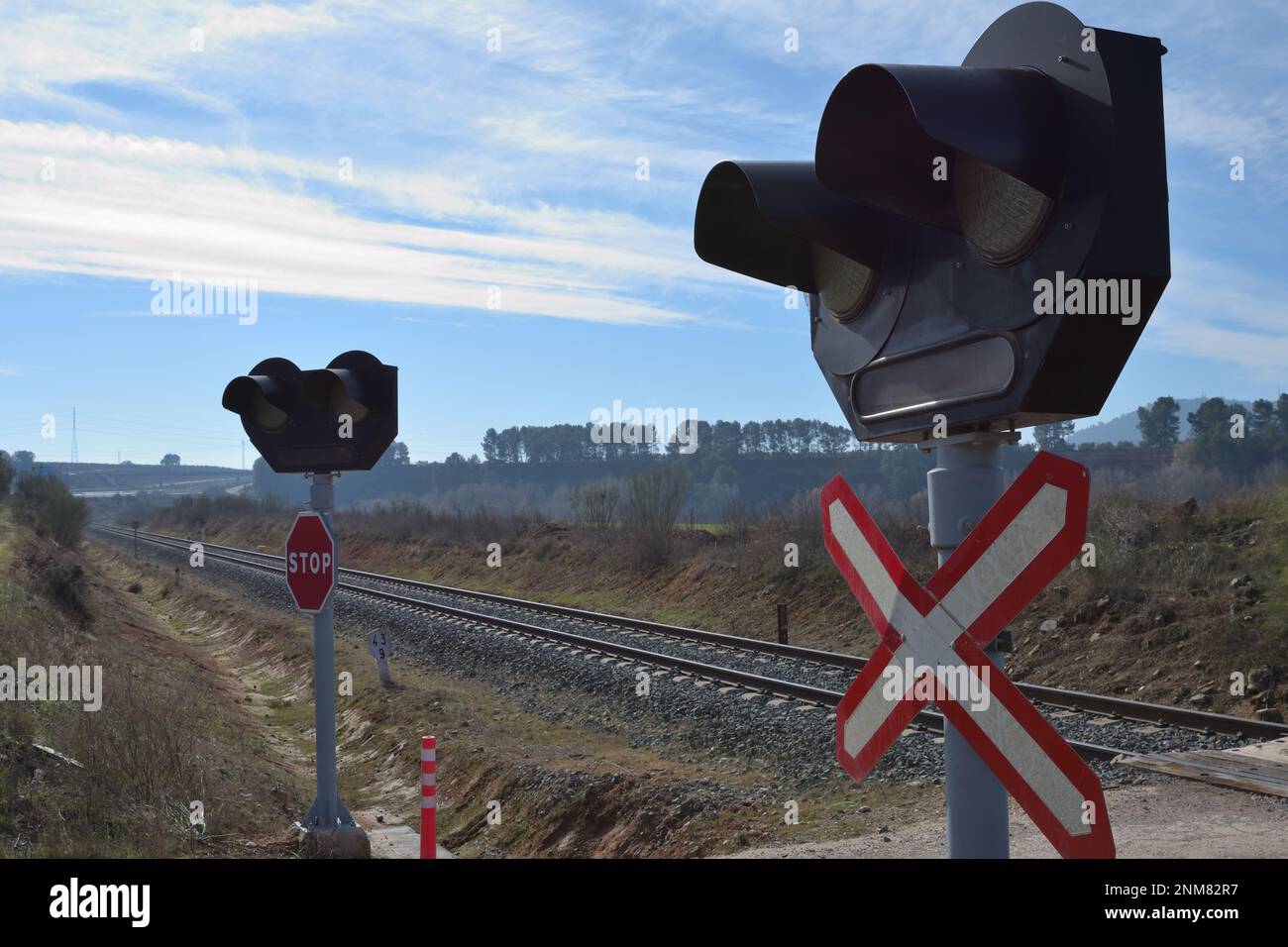 Warning signs on a road that crosses the train tracks Stock Photo - Alamy