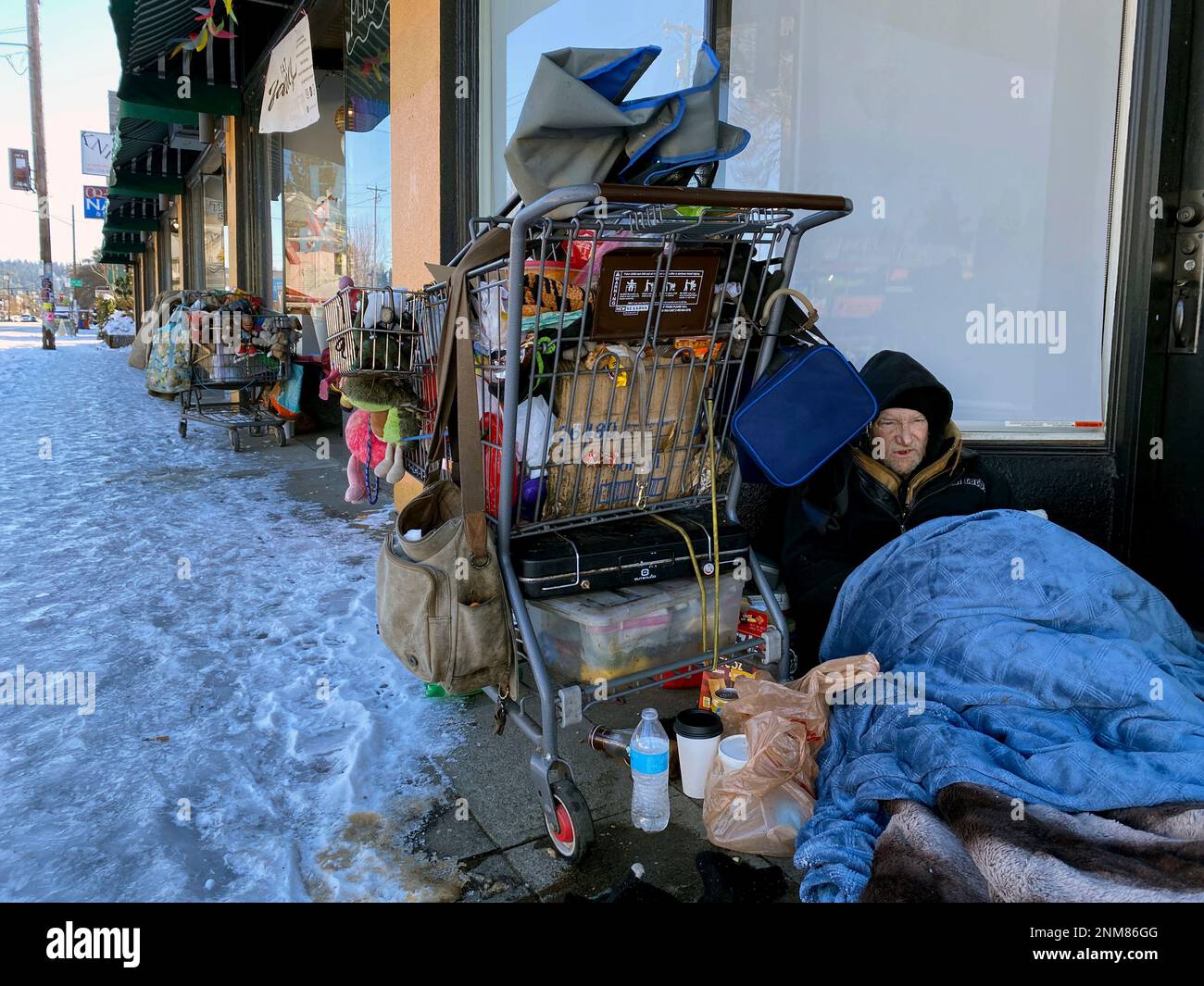Tim Varner, 57, uses blankets to stay warm in the snow as he huddles ...