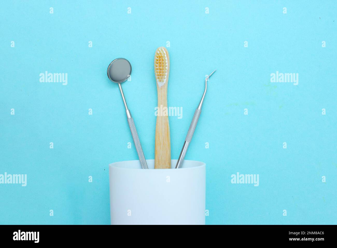 Different tools for dental care, toothbrush in plastic glass. Tooth ...