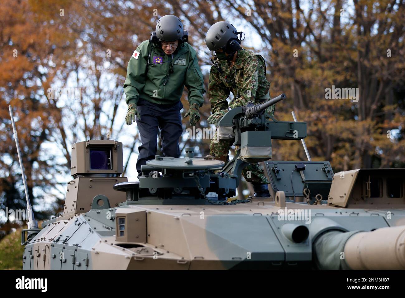 Japan's Prime Minister Fumio Kishida, left, rides on a Japan Ground ...