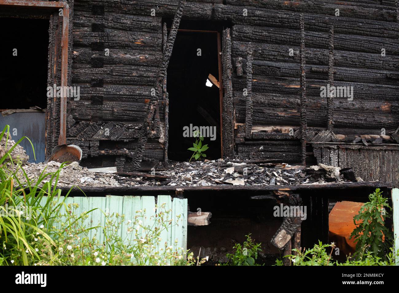 Burned wooden house, devastated construction and green grass Stock ...
