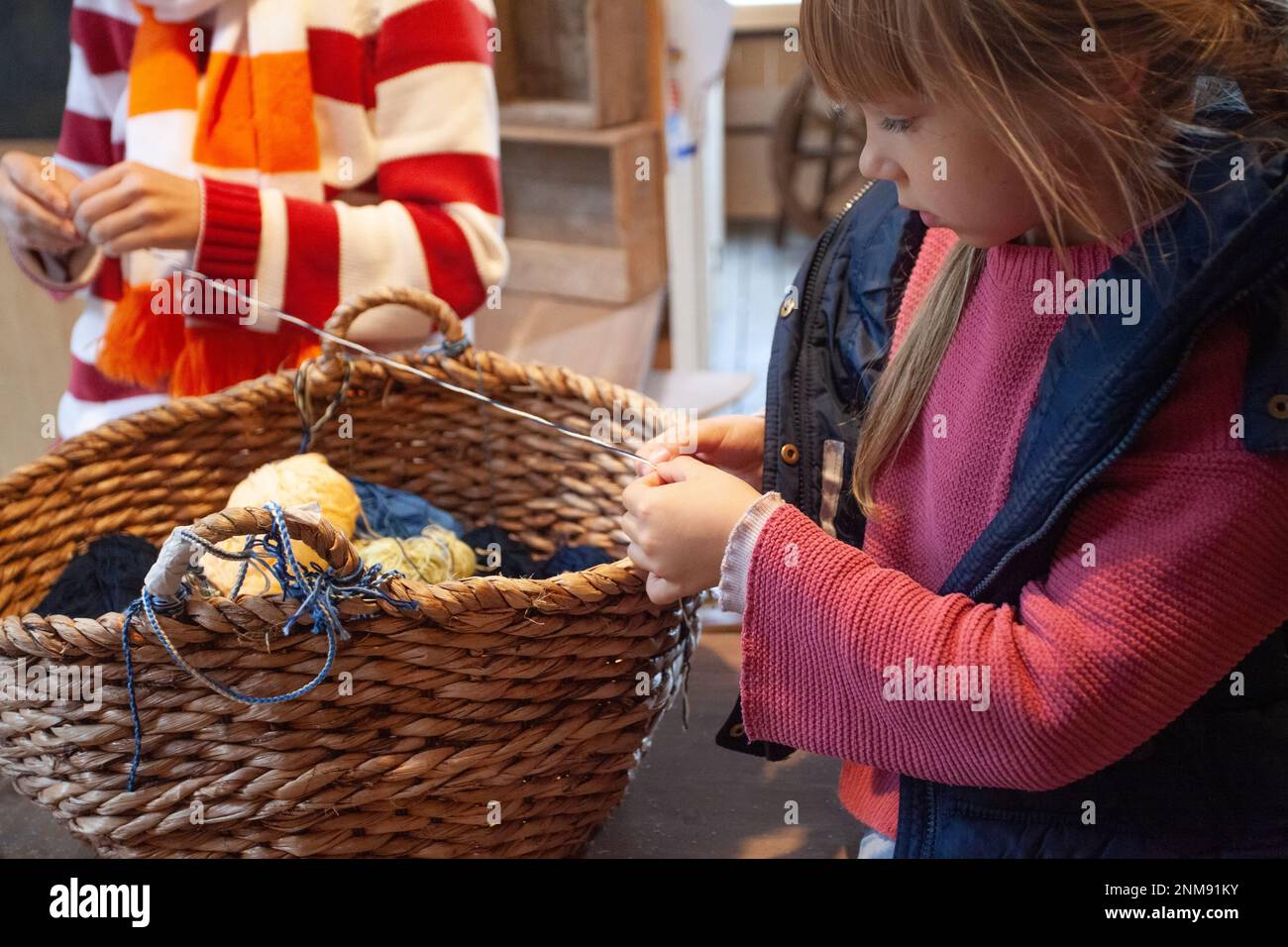Child girl with thread in hands Stock Photo - Alamy