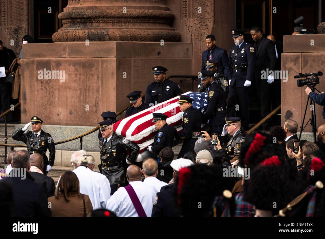 A honor guard carries the casket containing the remains of Temple ...