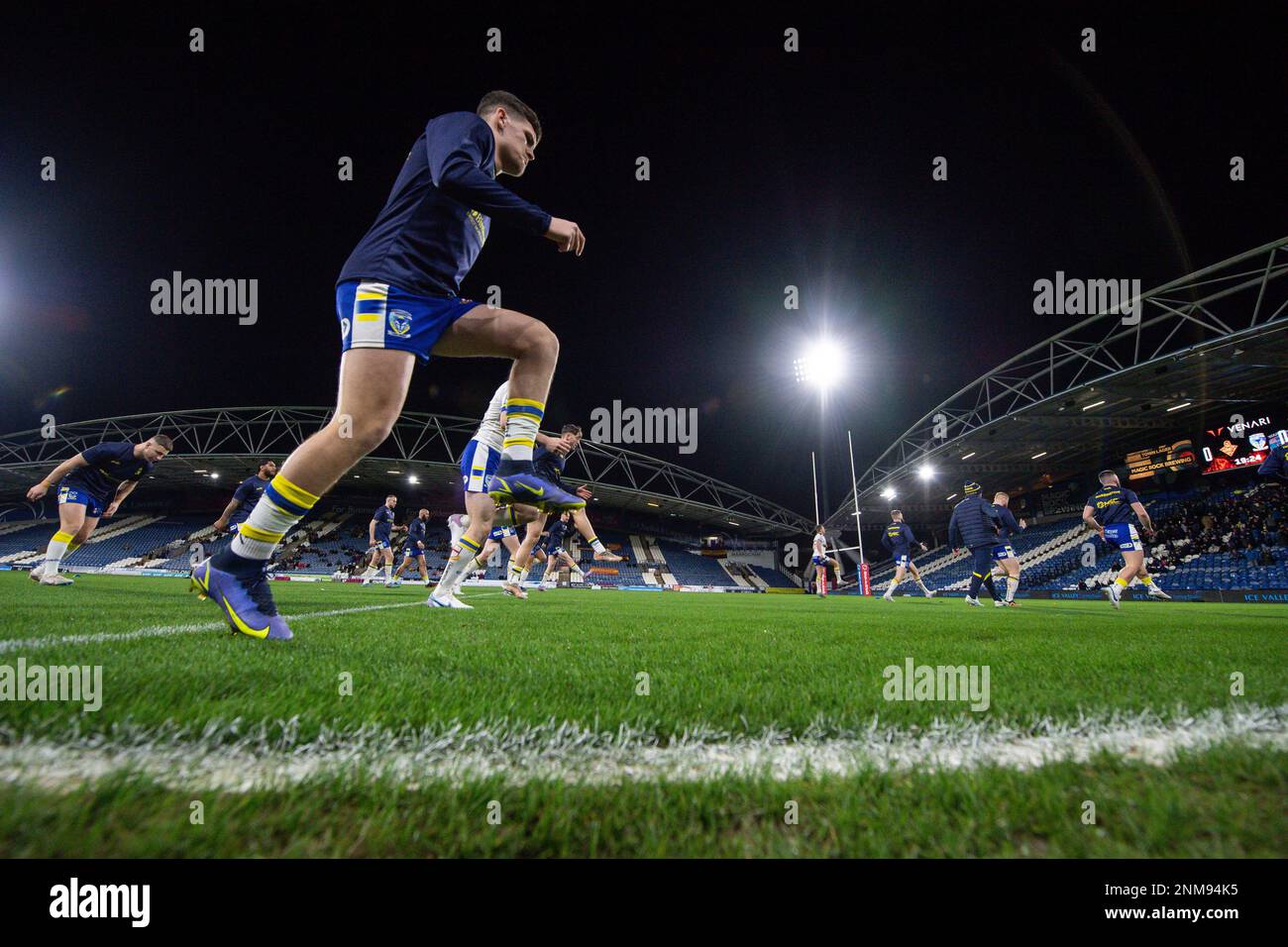 Josh Thewlis #2 of Warrington Wolves stretches during pre match warm up ...