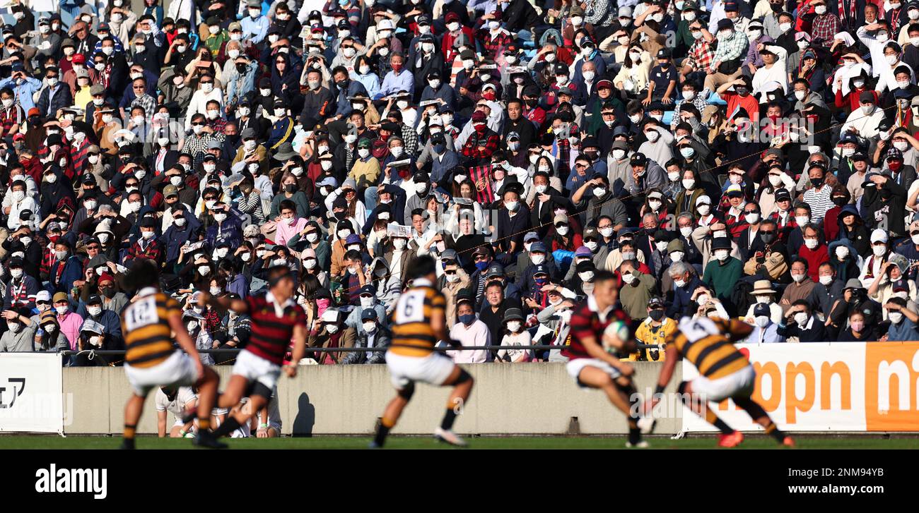 Spectators wearing masks enjoy watching a rugby match between Waseda ...