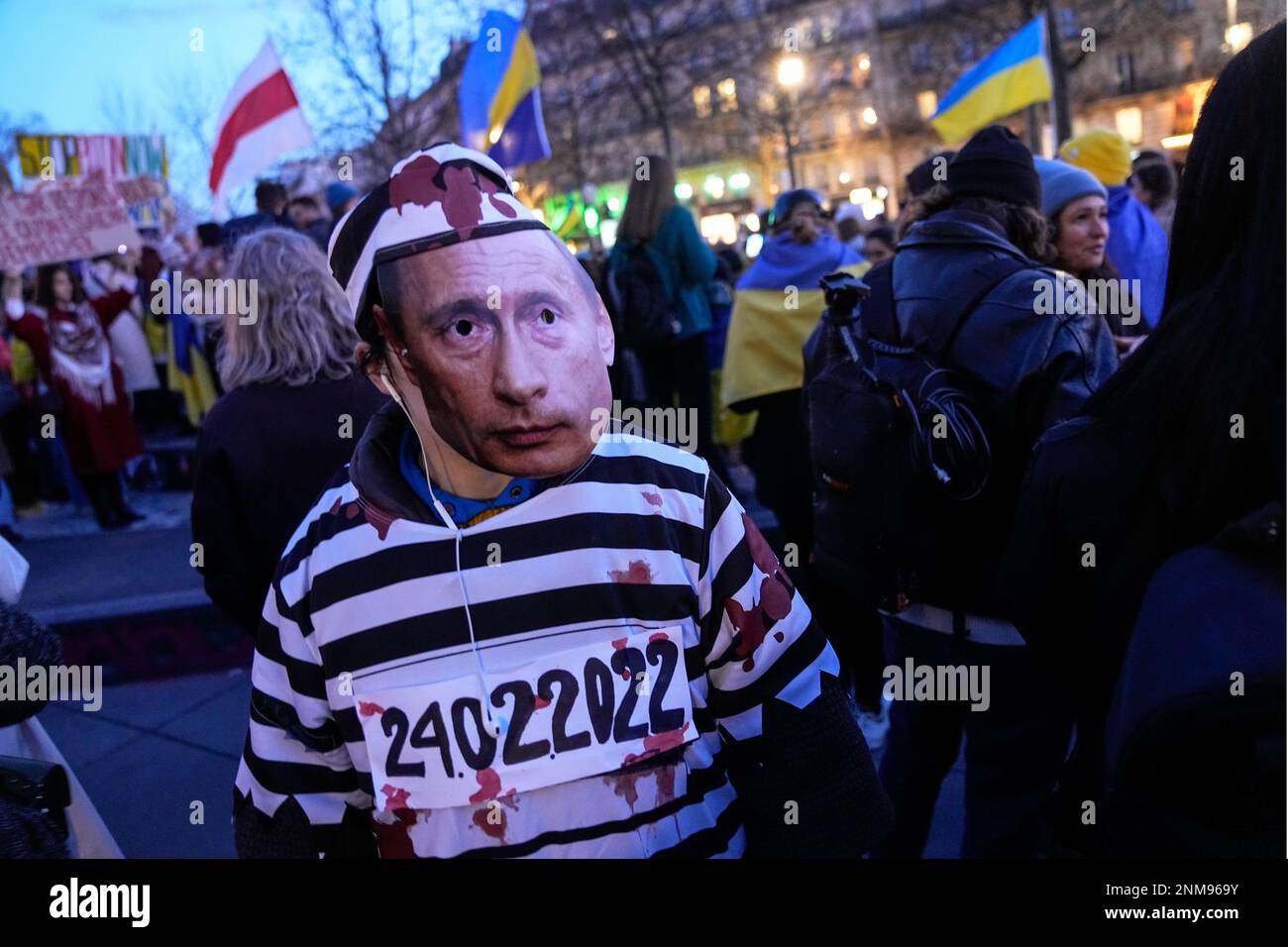 A Ukrainian supporter wearing a mask depicting Russian President ...