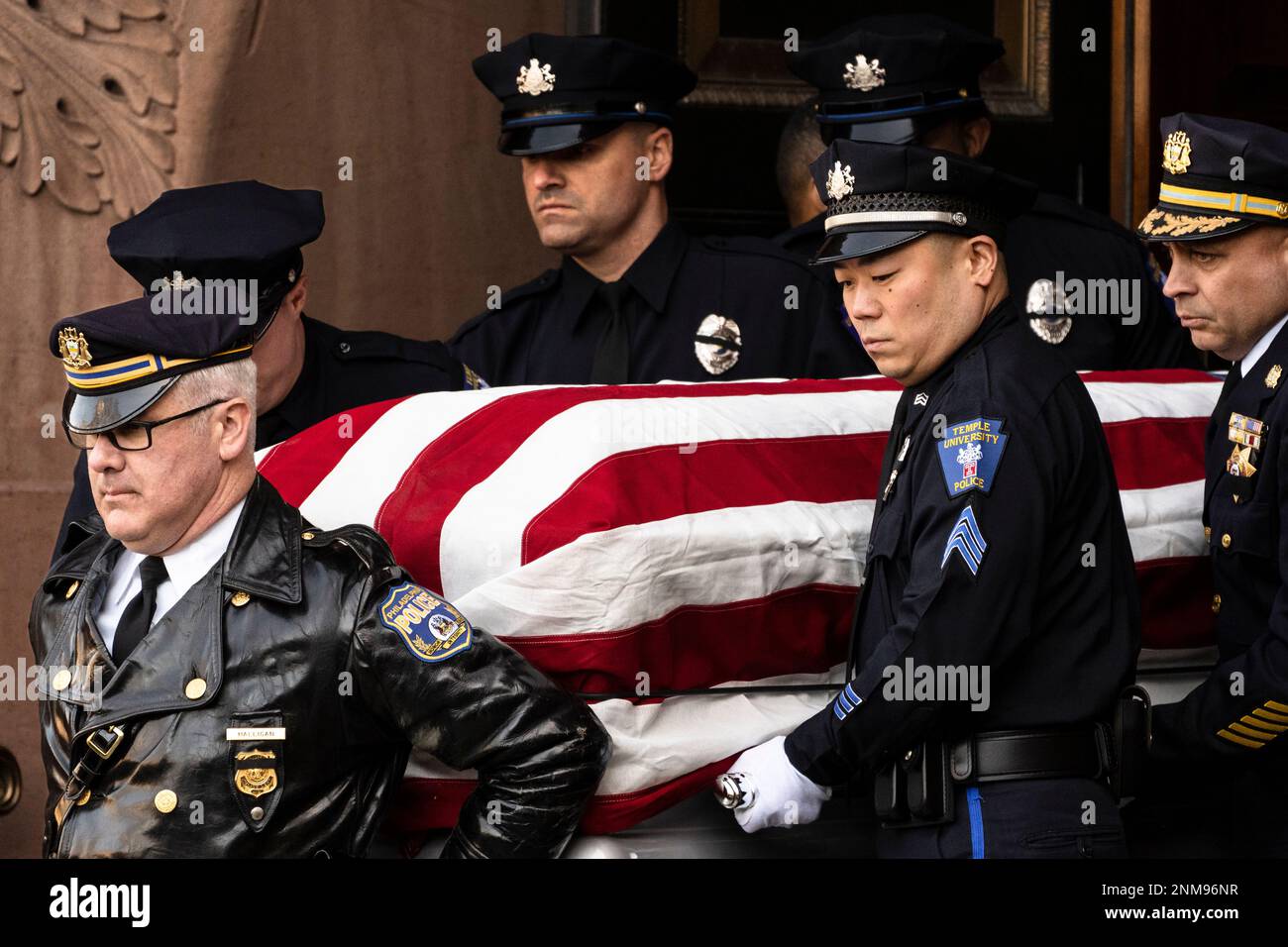 A honor guard carries the casket containing the remains of Temple ...