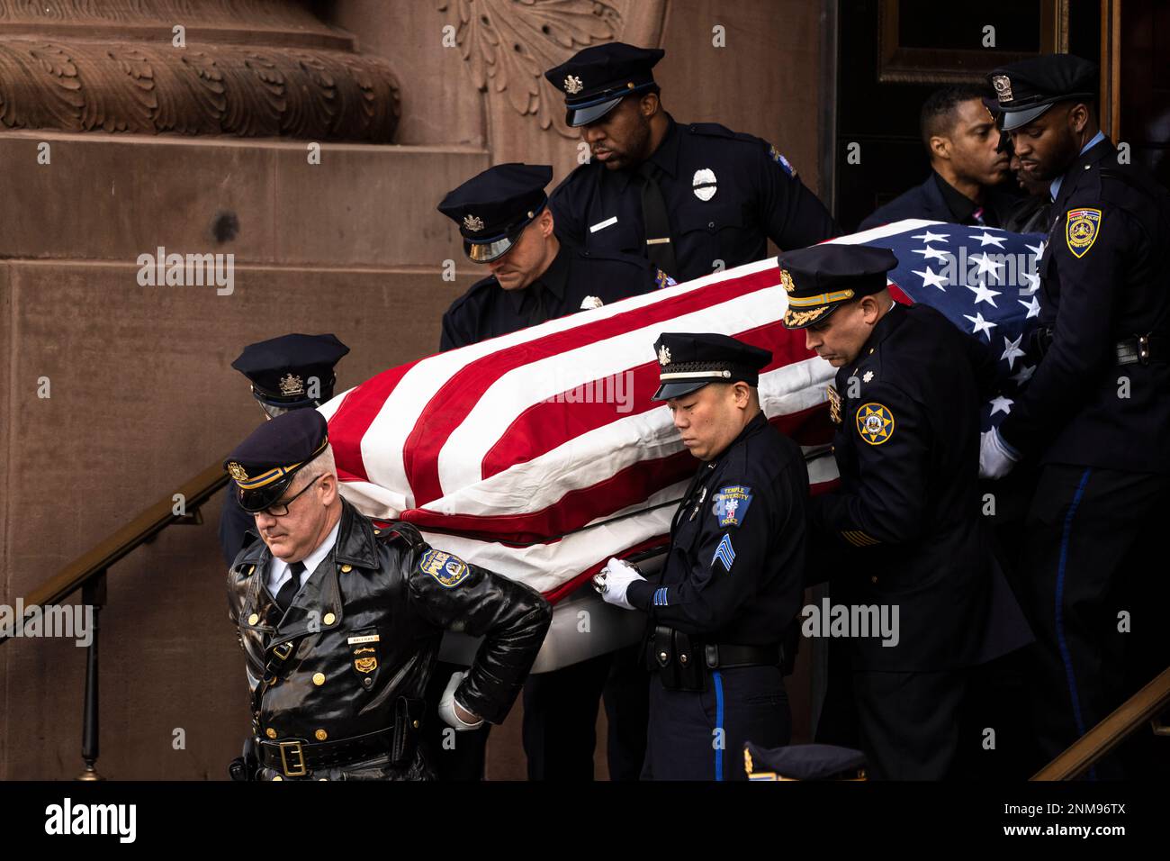 A honor guard carries the casket containing the remains of Temple ...