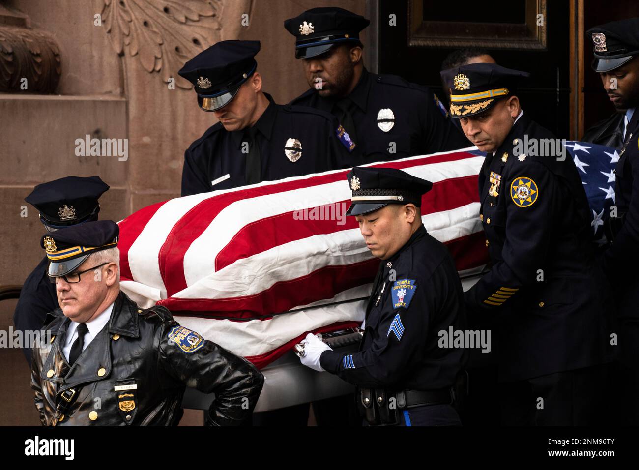 A honor guard carries the casket containing the remains of Temple ...