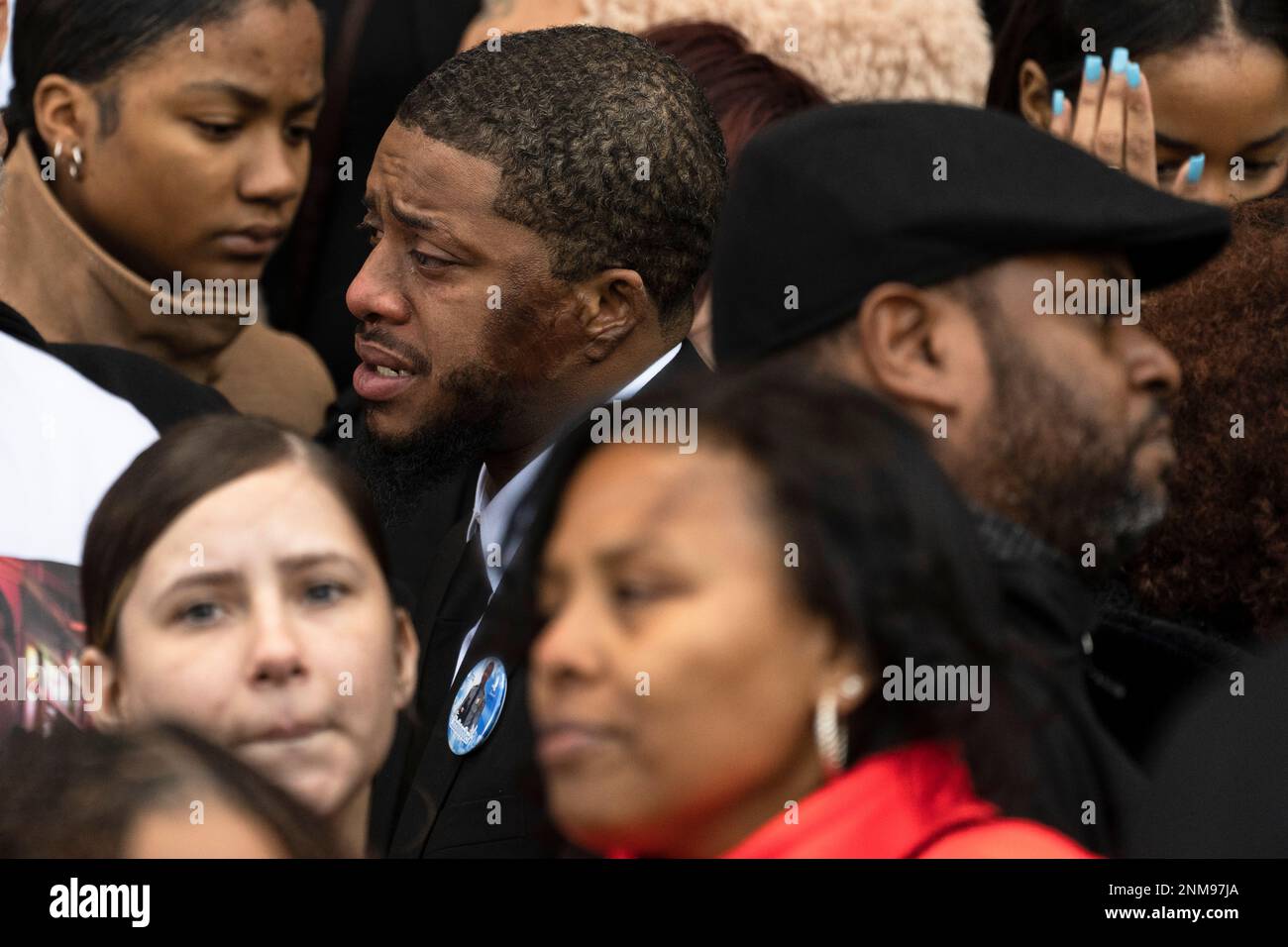 Mourners gather after a honor guard carried the casket containing the ...