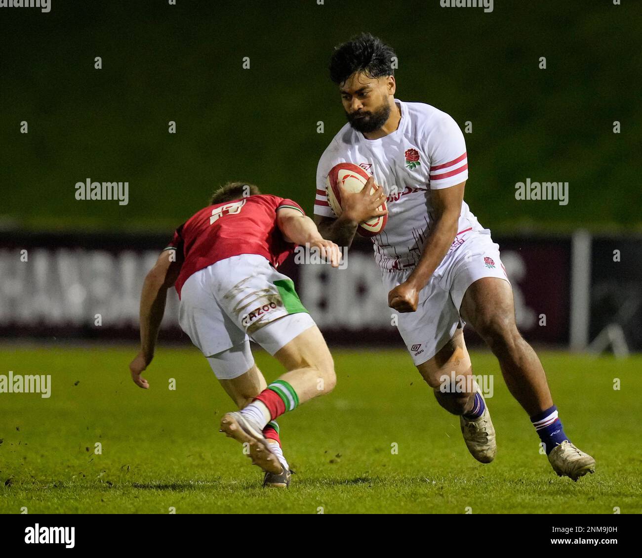 Rekeiti Ma'asi-White of England U20's runs at Archie Hughes #9 of Wales ...
