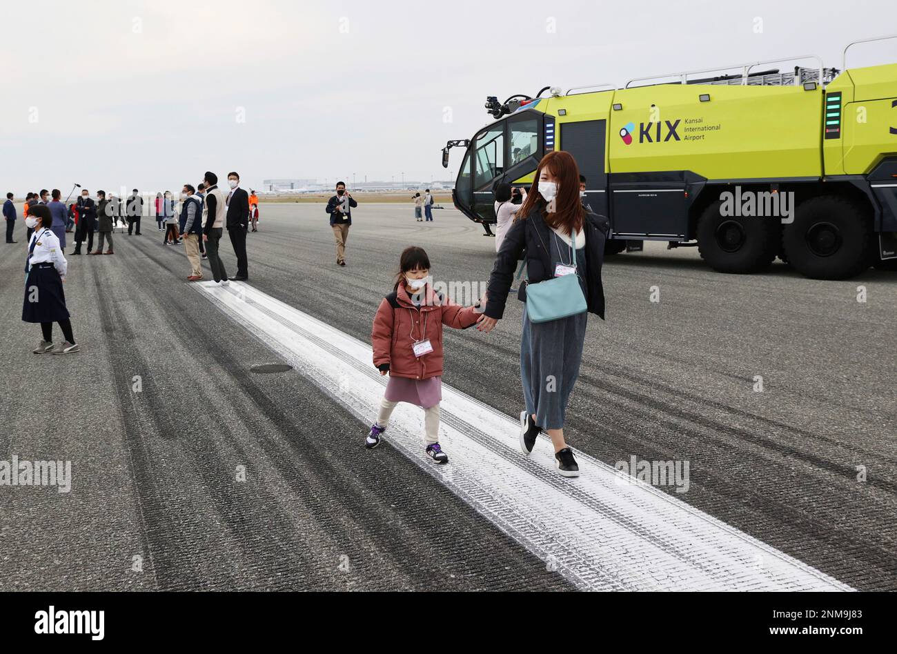 Participants walk on Runway A during an event "KIX Runway Walk" at ...