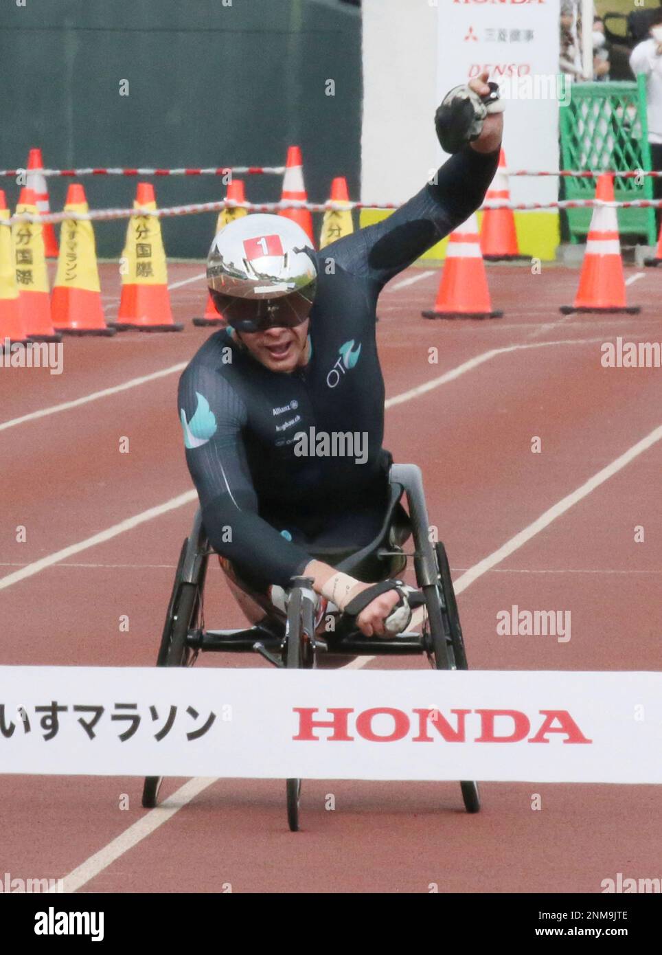 Marcel Eric Hug of Switzerland crosses a finish line during Oita ...