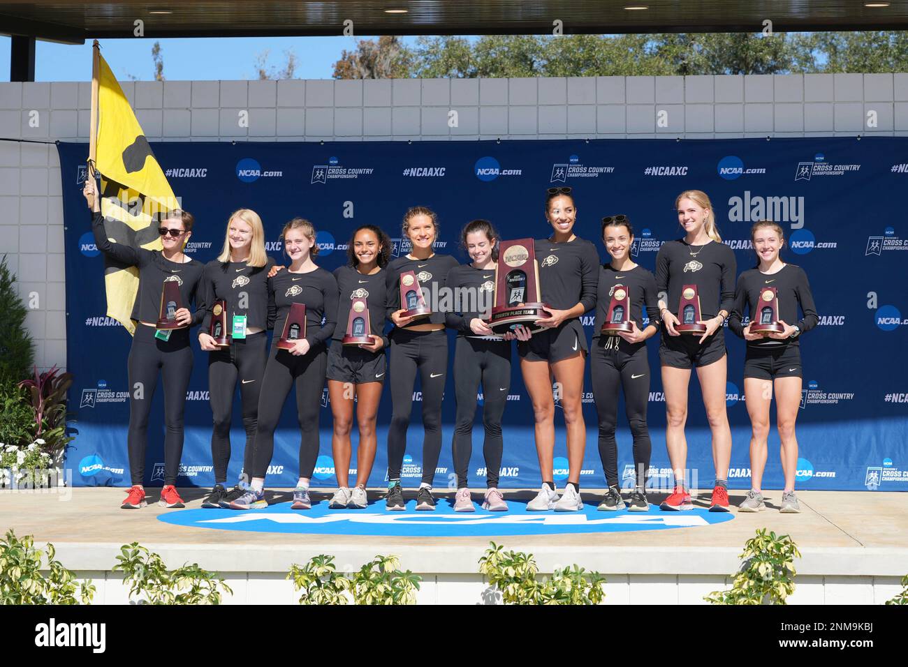 The Colorado Buffaloes women's team pose with team trophy after placing ...