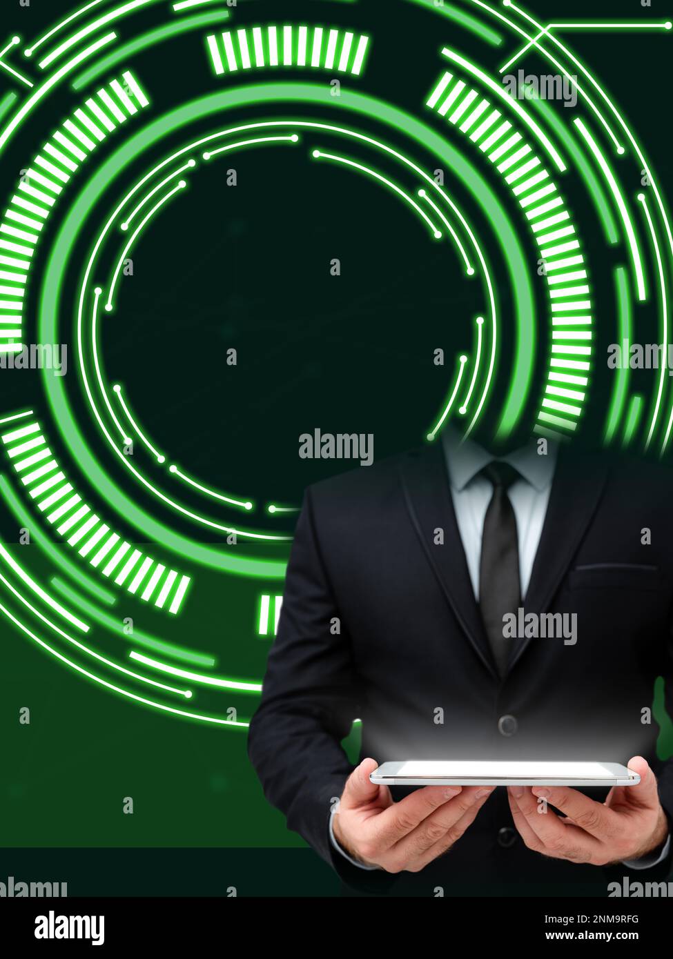 Businessman in black suit standing and holding tablet in two hands ...
