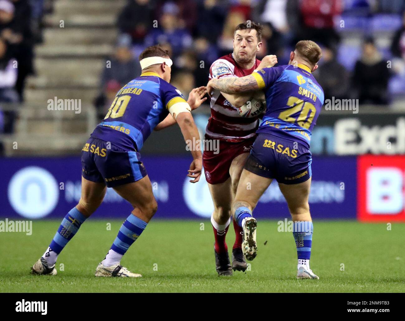 Wigan Warriors' Jake Wardle (centre) tackled by Wakefield Trinity's Jai ...