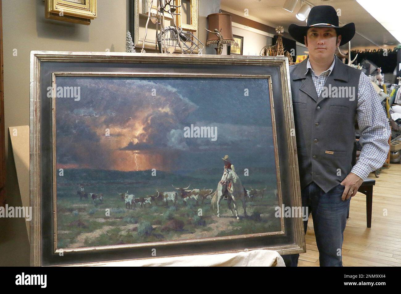 Brandon Bailey stands next to one of his original paintings that he ...