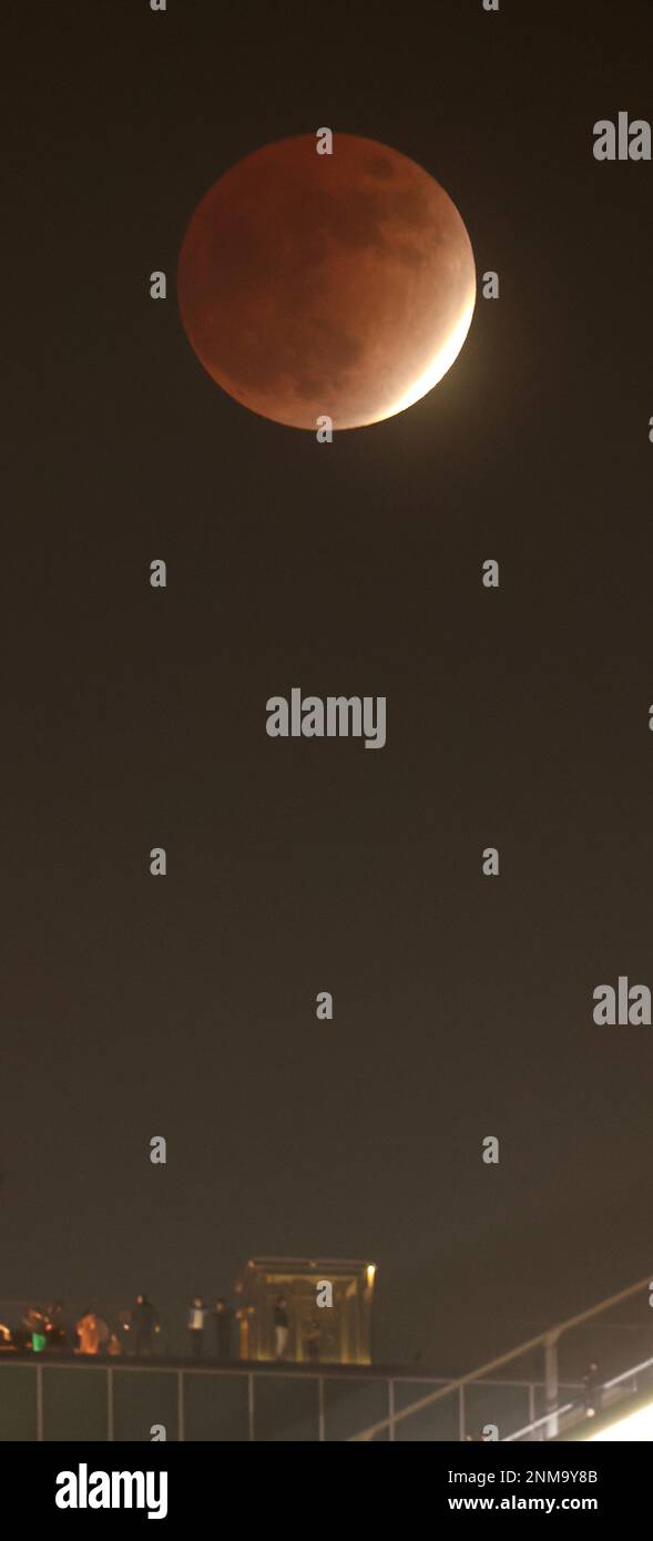 A photo shows a partial lunar eclipse seen in Shibuya, Tokyo on Nov. 19 ...