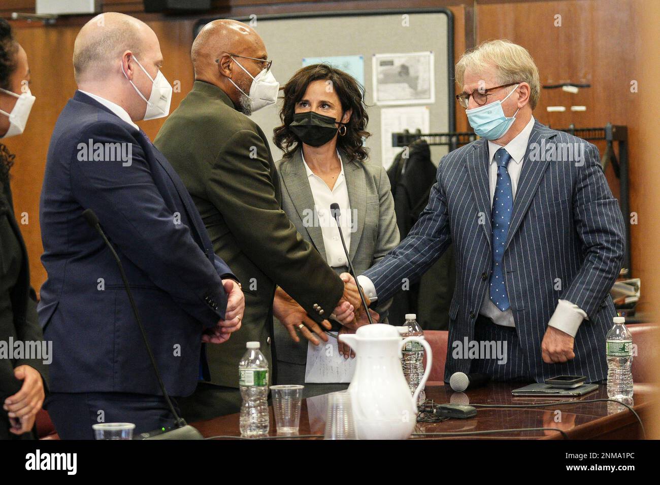 Muhammad Aziz , second from left, shakes hands with attorney Barry ...