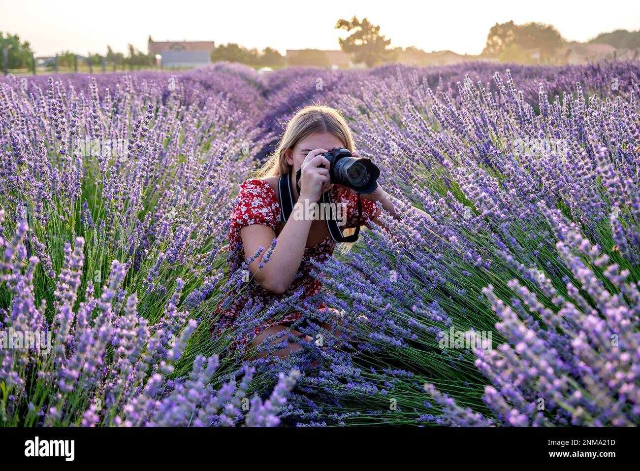 Beautiful woman taking pictures outdoors with a DSLR camera. Female ...