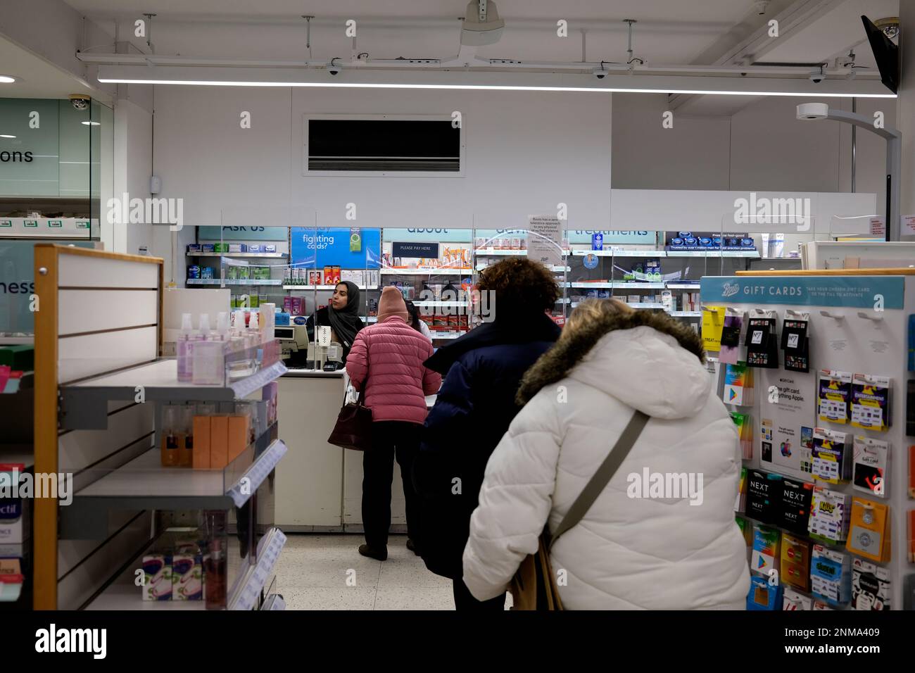 customers at prescription counter in boots chemist,whitstable town,east ...