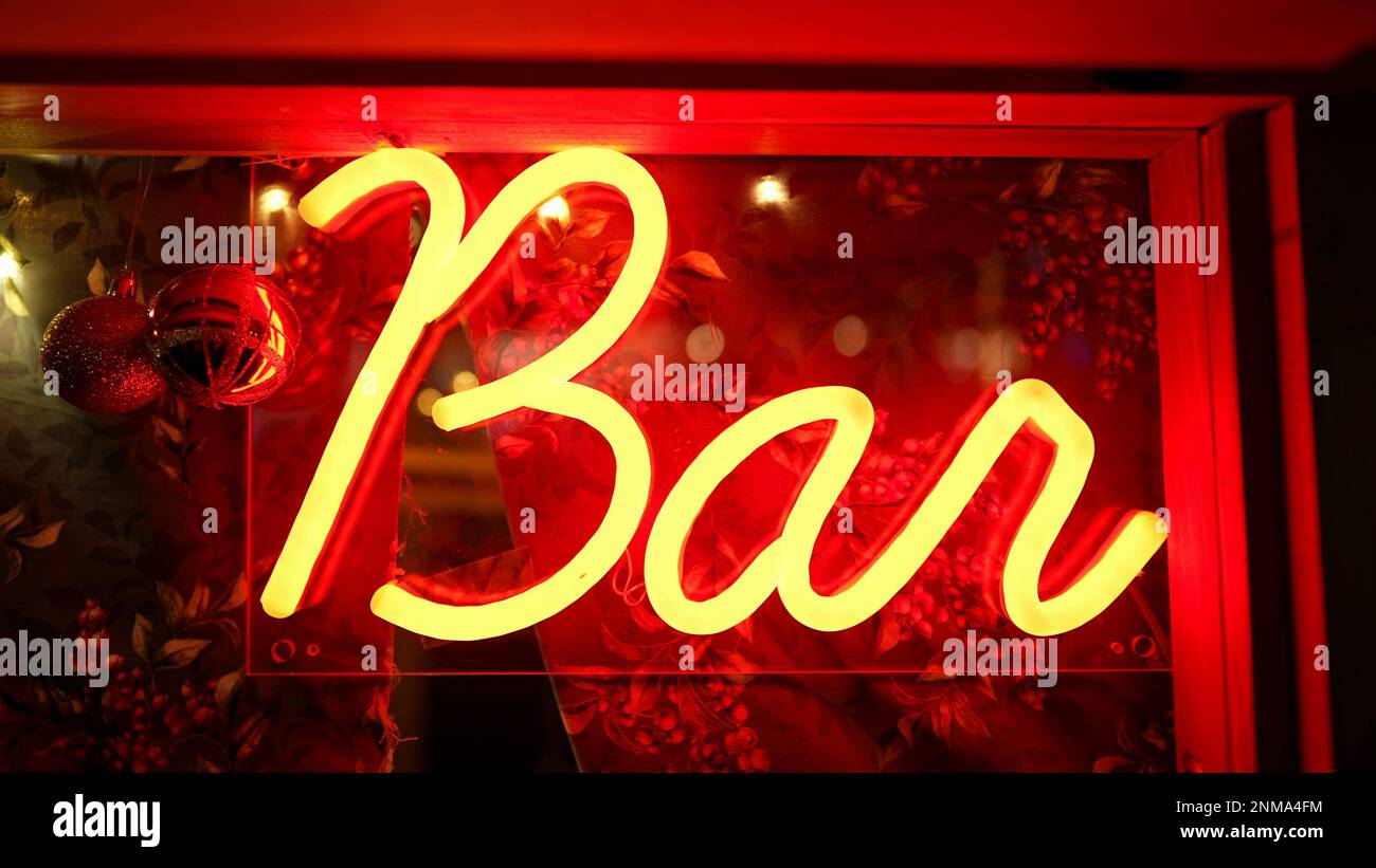 Bar neon sign in bright red color display. Entertainment signal ...