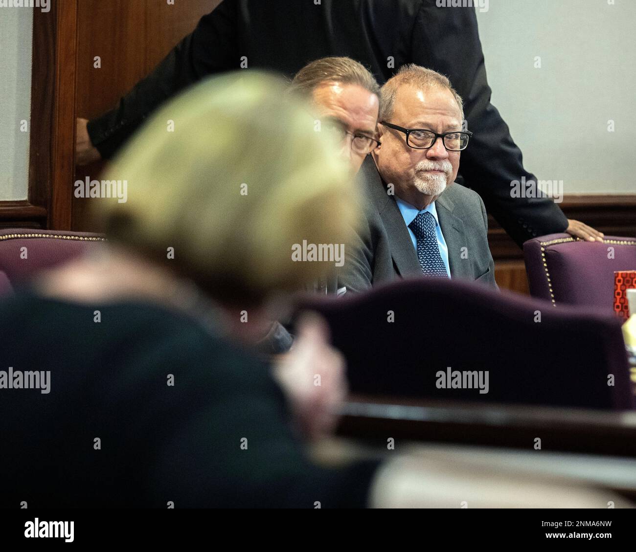 Greg McMichael looks at his wife Leigh McMichael, left, as she give him ...
