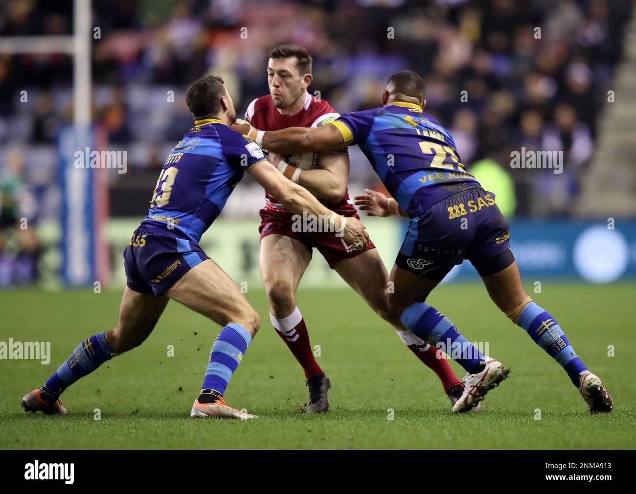Wigan Warriors' Jake Wardle (centre) tackled by Wakefield Trinity's Jay ...