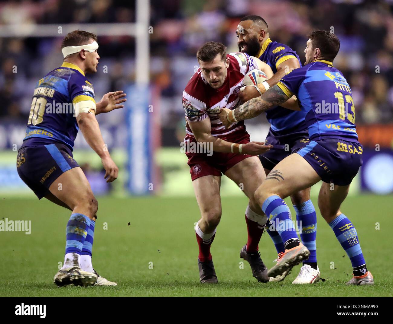 Wigan Warriors' Jake Wardle (centre) tackled by Wakefield Trinity's Jay ...