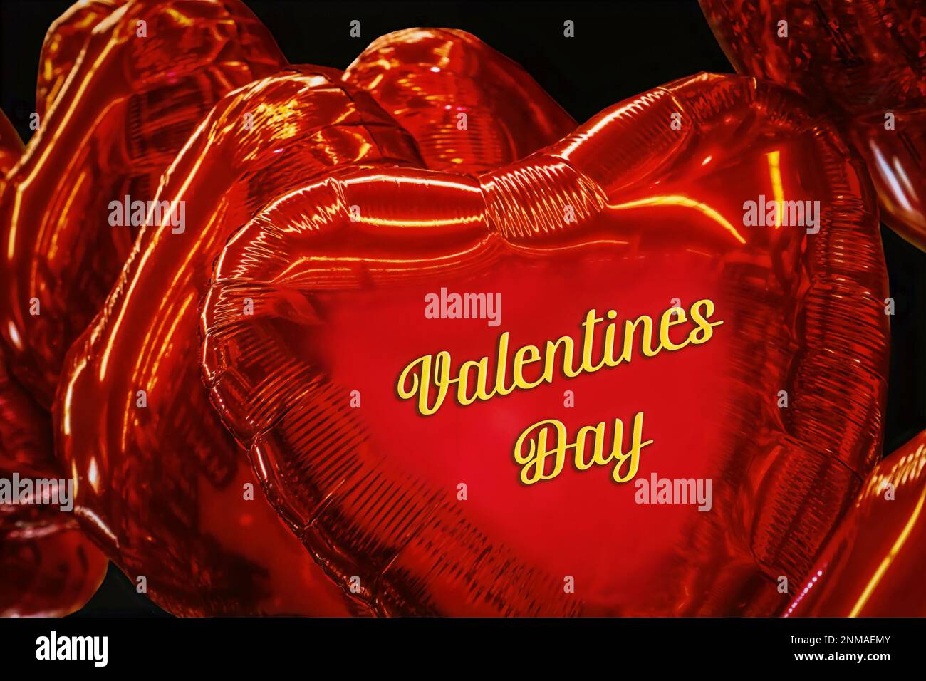 Bright red heart shaped mylar balloons Background says Valentines Day ...