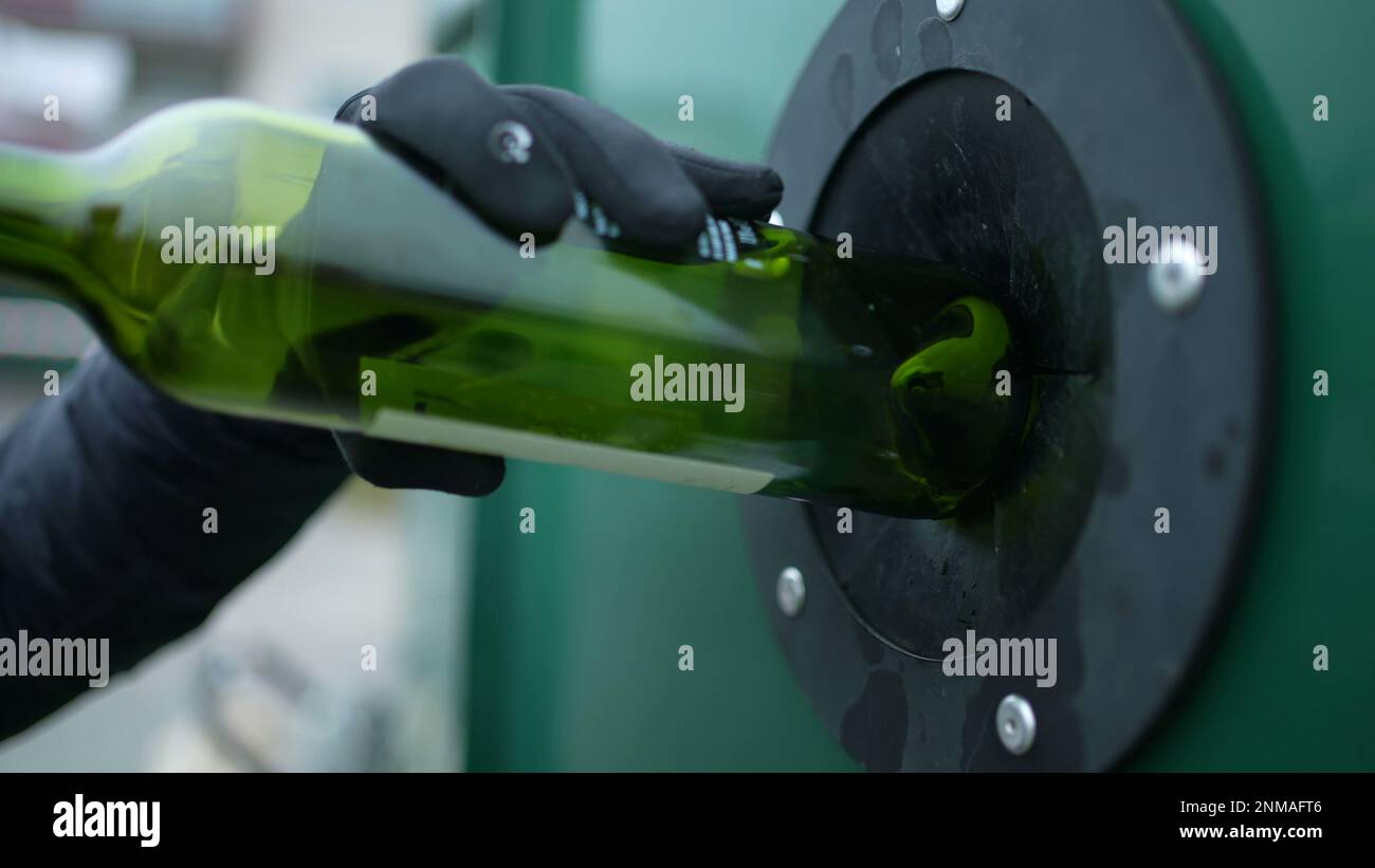 Recycling glass bottles in dispenser machine. Person hands inserting ...