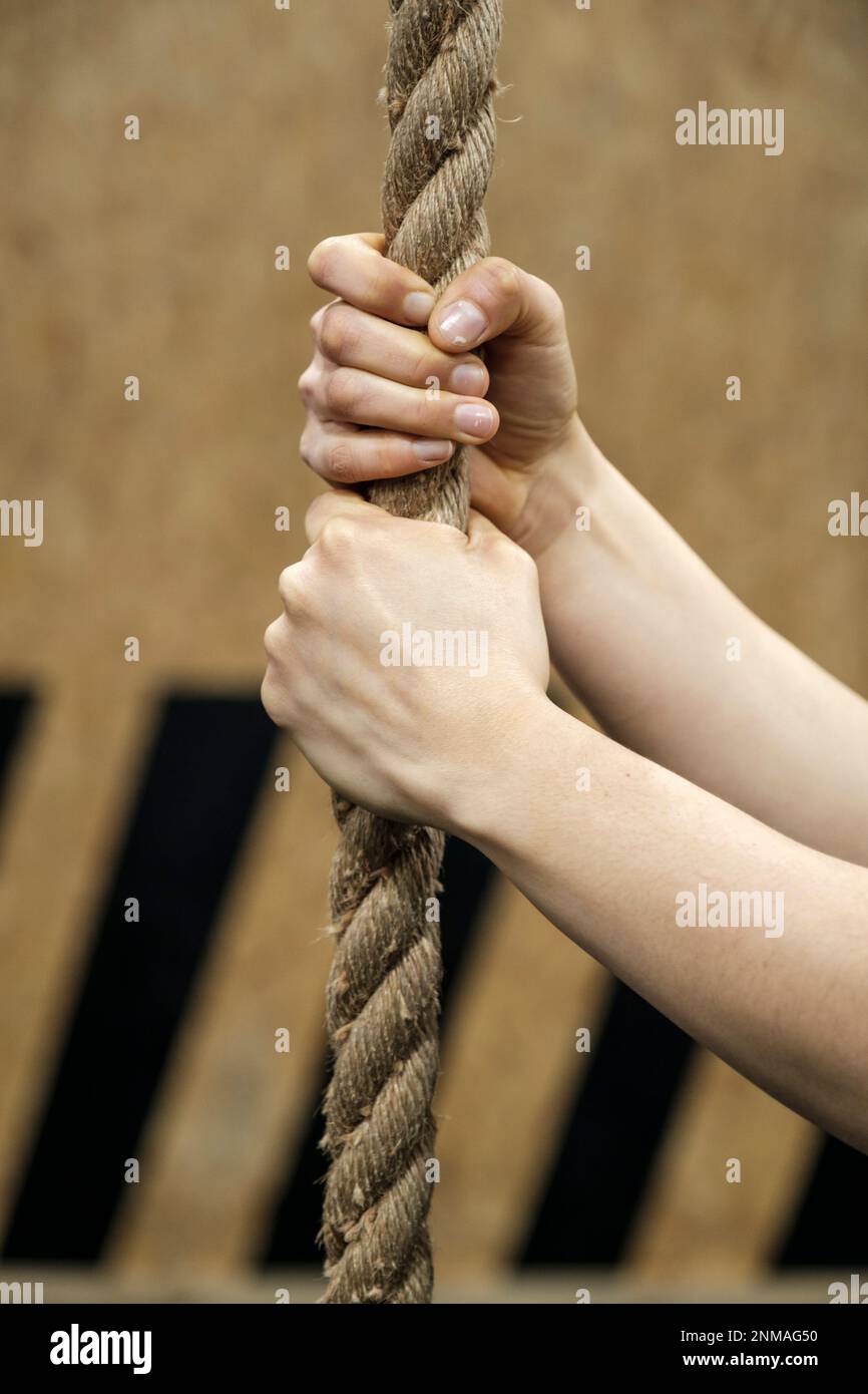 Fit woman's hands taking rope in gym Stock Photo - Alamy