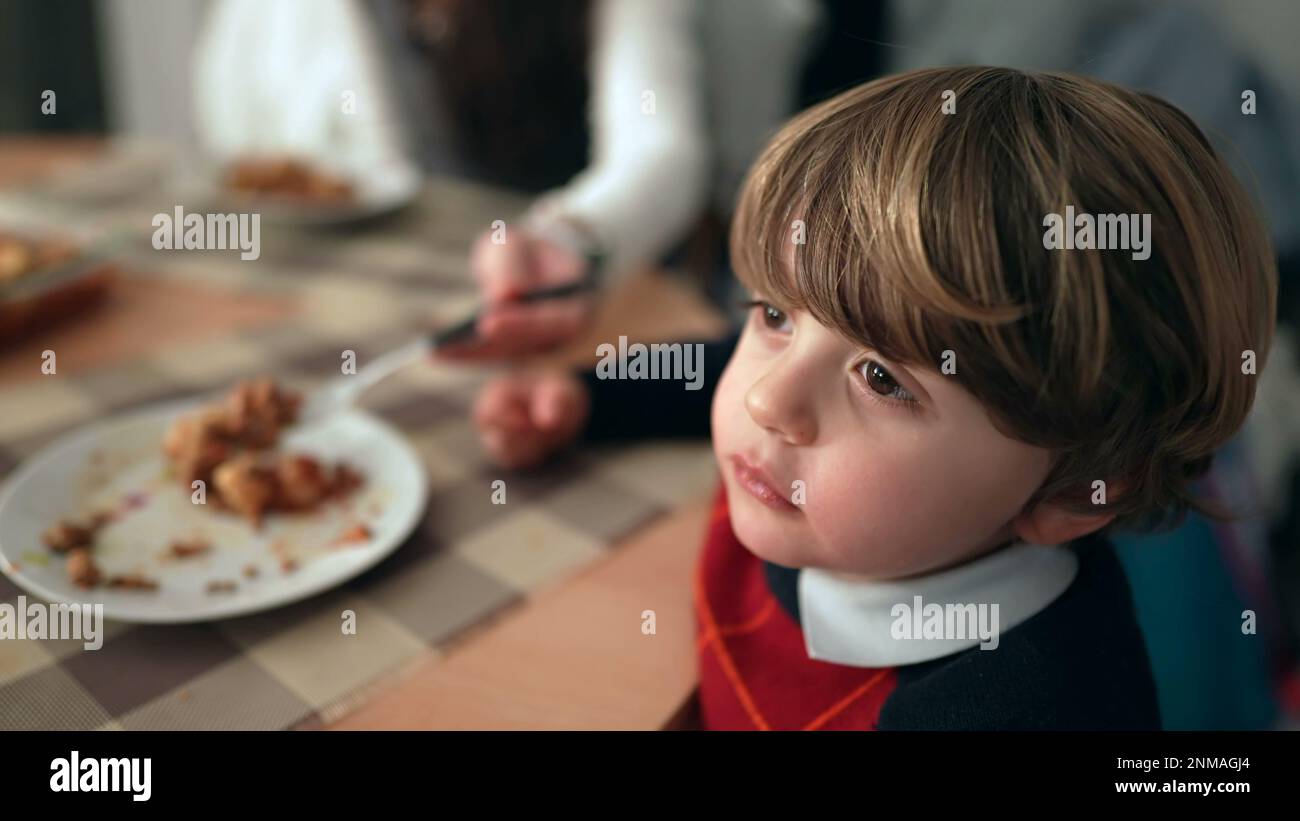 One happy little boy eating food wearing sweater indoors during winter ...