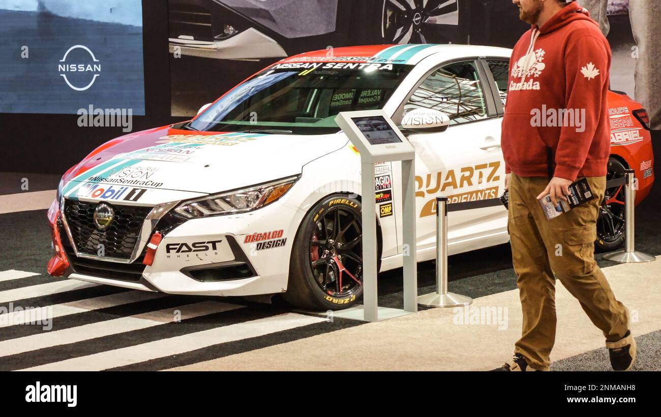 View of Nissan Sentra sport car on display. Crowds looking at new car ...