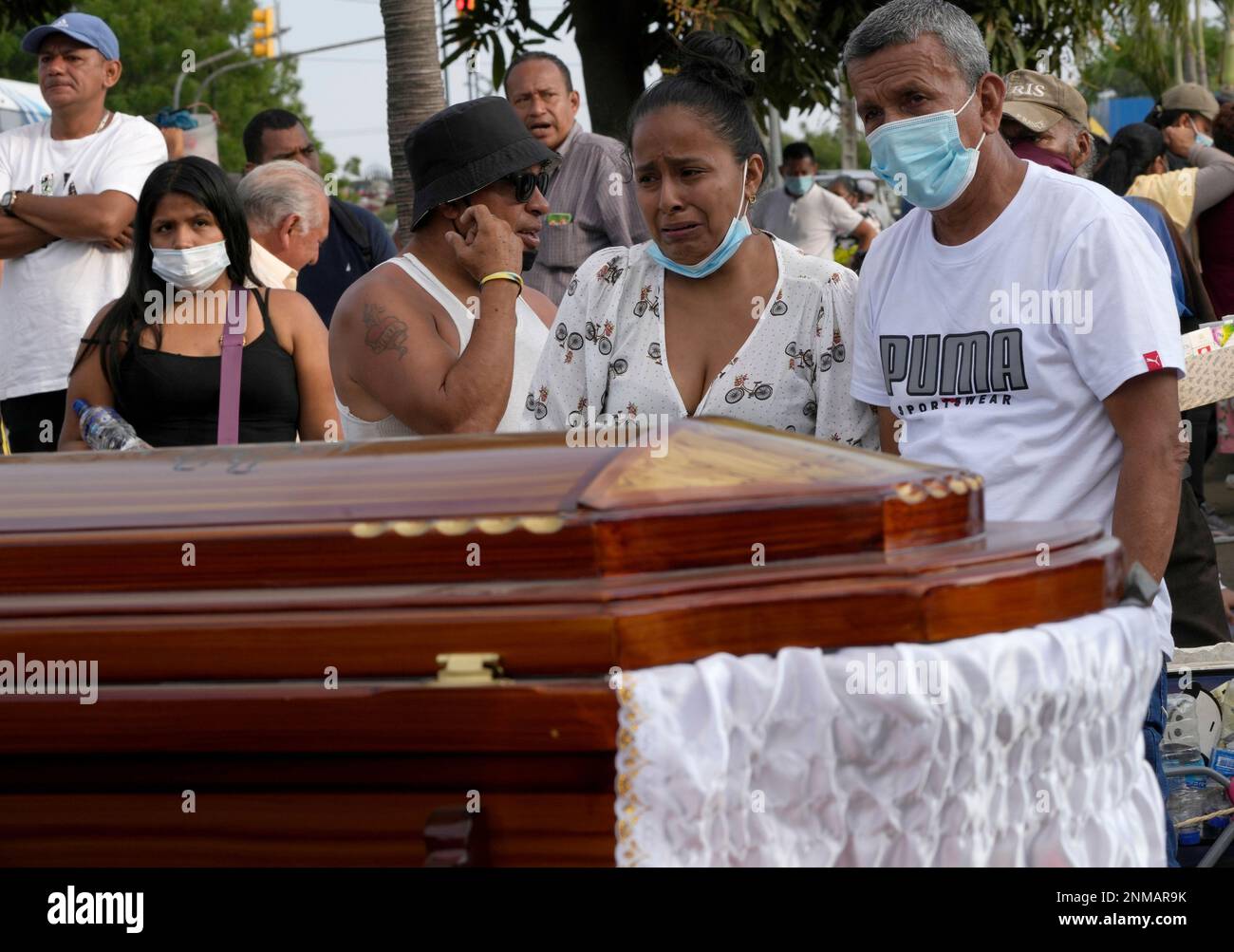 Relatives cry as they receive the coffin with the remains of their ...