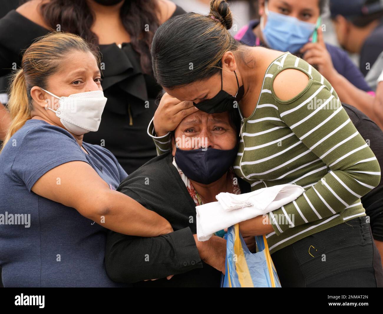 Relatives wait outside the morgue for news on their relatives who were ...