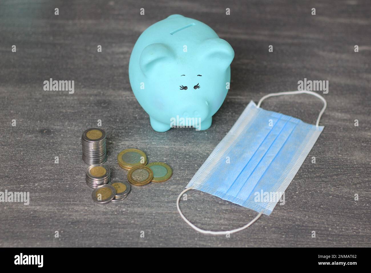 Coins of mexican pesos and protection mask, savings and finances during ...