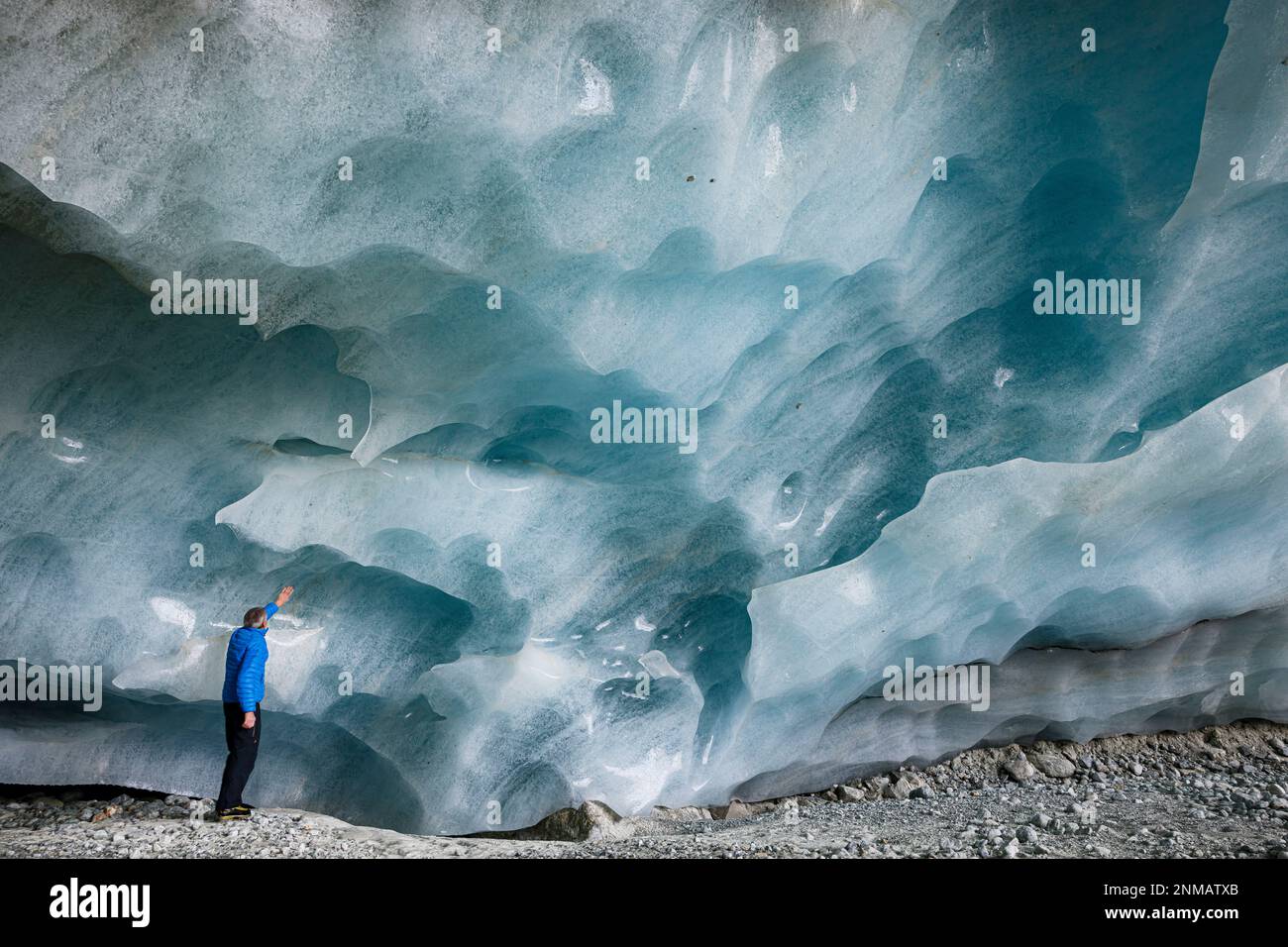 Mountain guide Daniel Ruppen visits an ice cave formed at the end ...