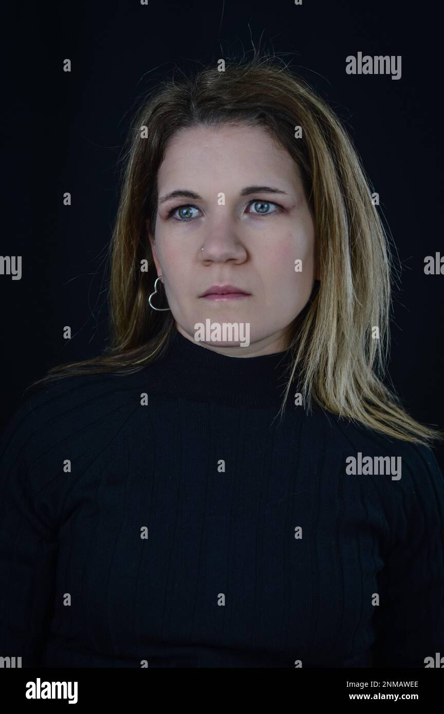 portrait of a beautiful blonde woman with a very sad look who looks ...