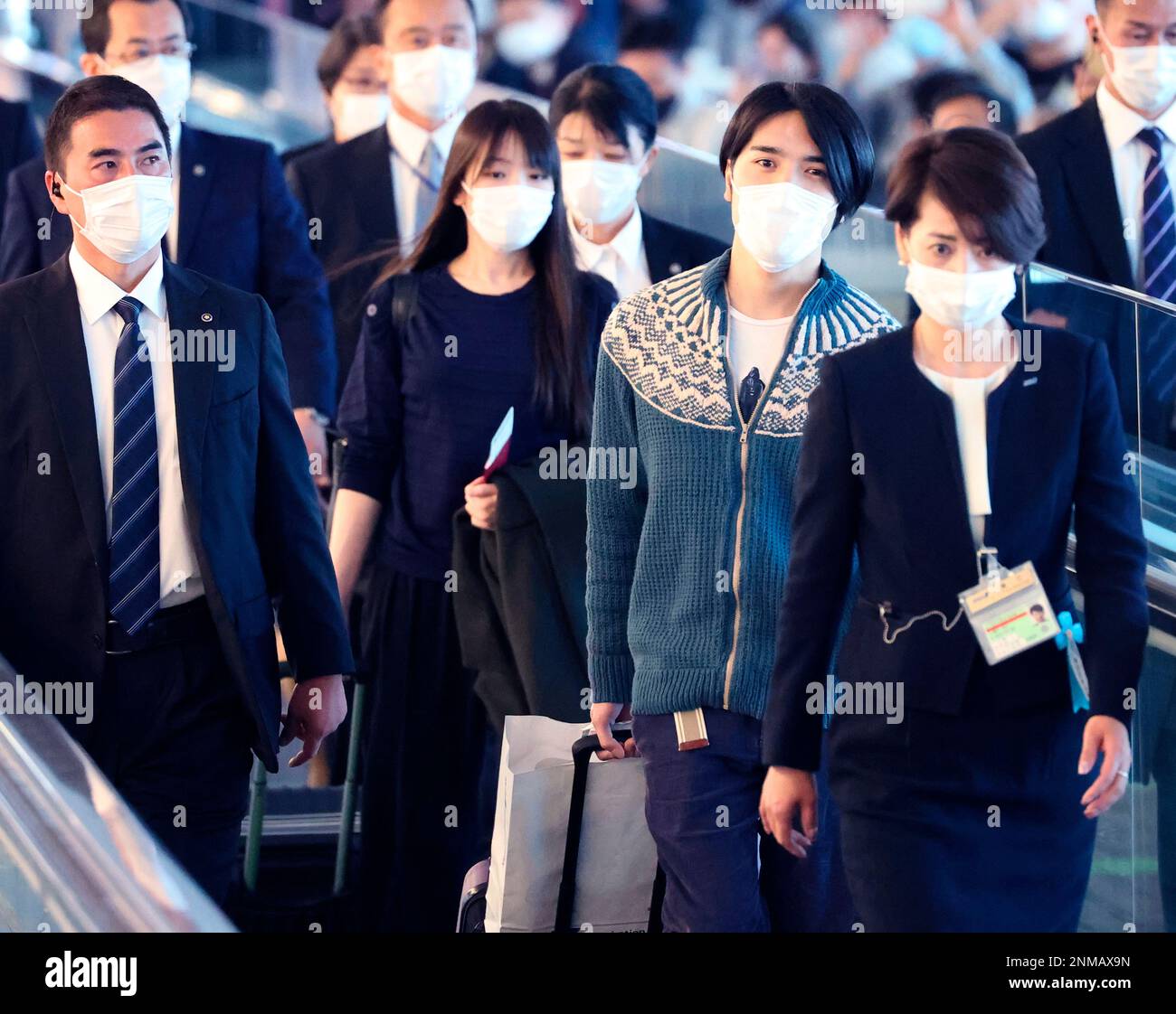Kei Komuro (R) and Mako, Japanese former Princess, head for an airplane ...