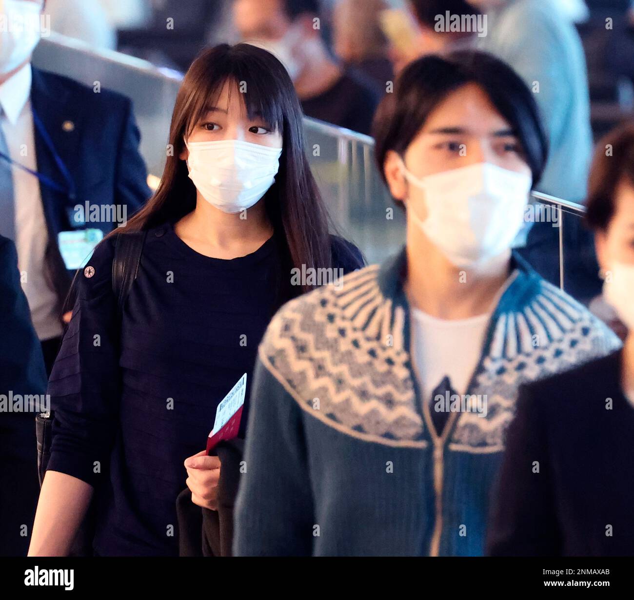 Kei Komuro (R) and Mako, Japanese former Princess, head for an airplane ...