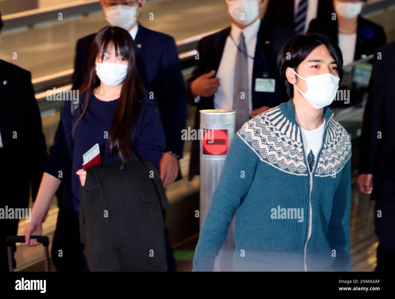 Kei Komuro (R) and Mako, Japanese former Princess, head for an airplane ...