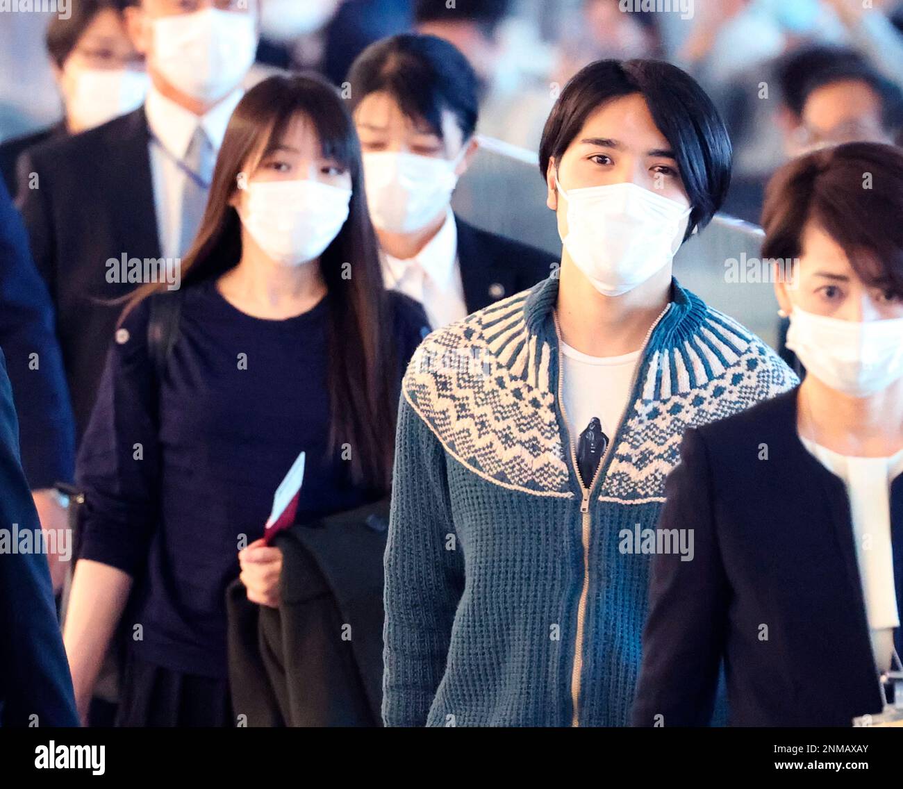 Kei Komuro (R) and Mako, Japanese former Princess, head for an airplane ...