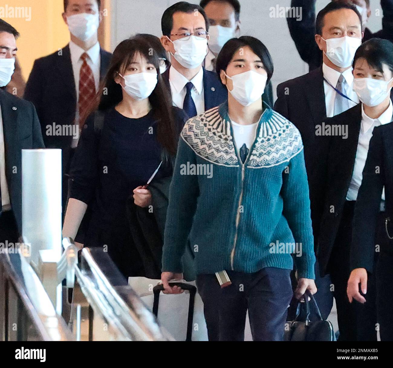 Kei Komuro (R) and Mako, Japanese former Princess, head for an airplane ...