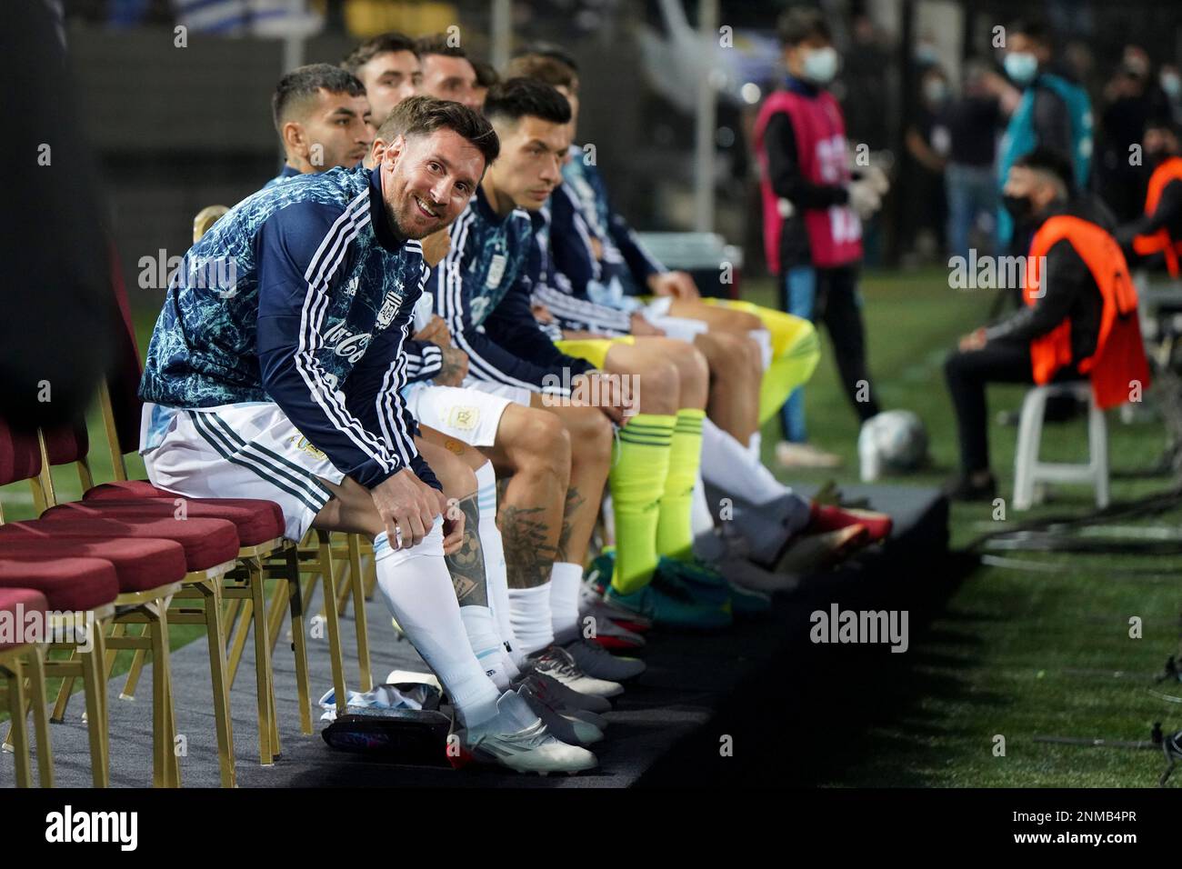 Argentina's Lionel Messi smiles as he sits on the bench during a ...