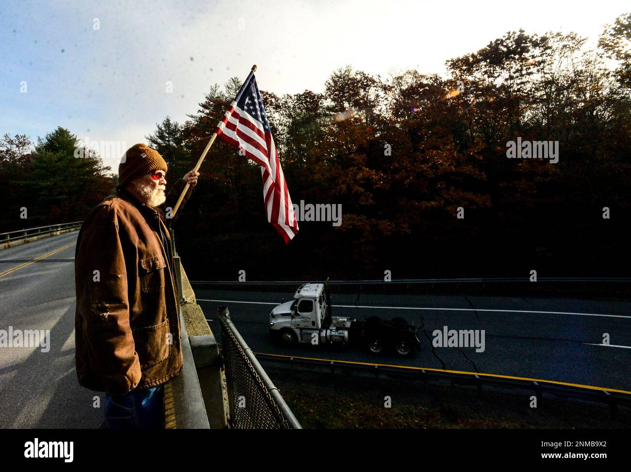 Navy veteran Jerry Wilkinson, from Westminster, Vt., holds an American ...