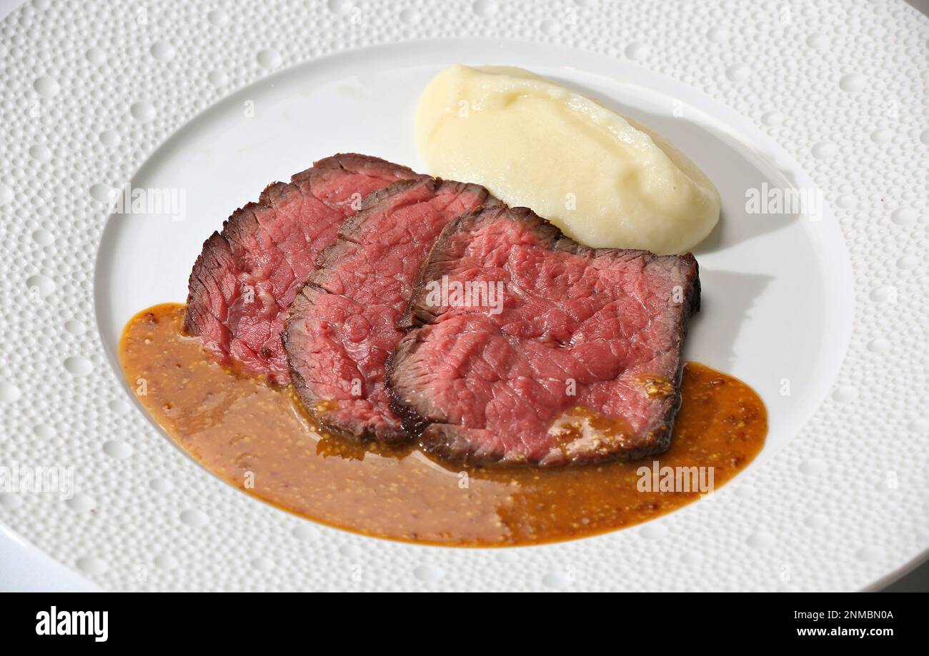A picture shows a dish of roast beef, a traditional cuisine of beef ...