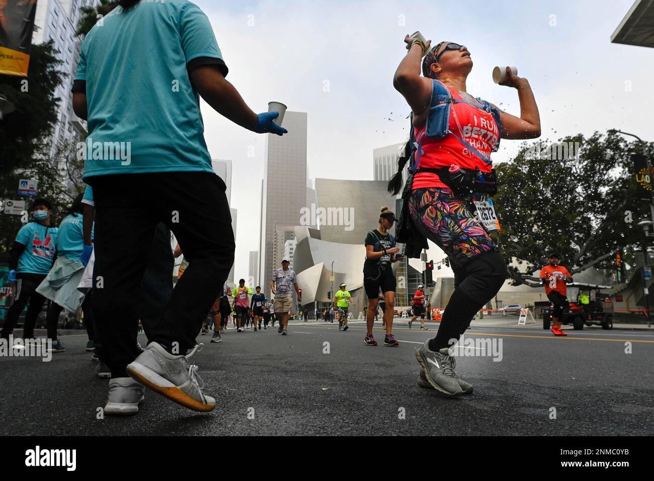 Runners grab water in front of the Dorothy Chandler Pavilion along ...