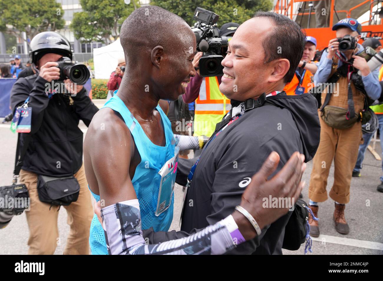 John Korir (KEN), left, celebrates with Asics director of sports ...